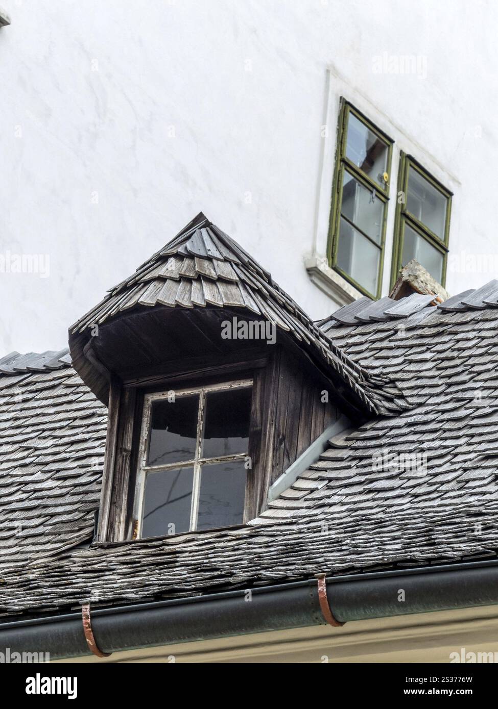 Old house with dormer and shingles. Old architecture revitalised ...
