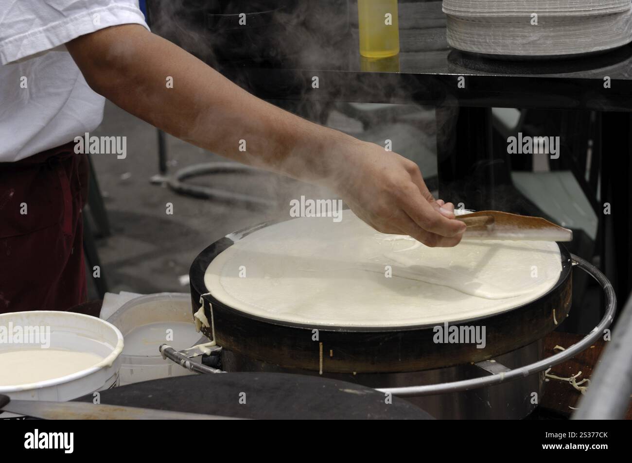 Person making a pancake crepe on a stove Italian cuisine Taste of Italy ...