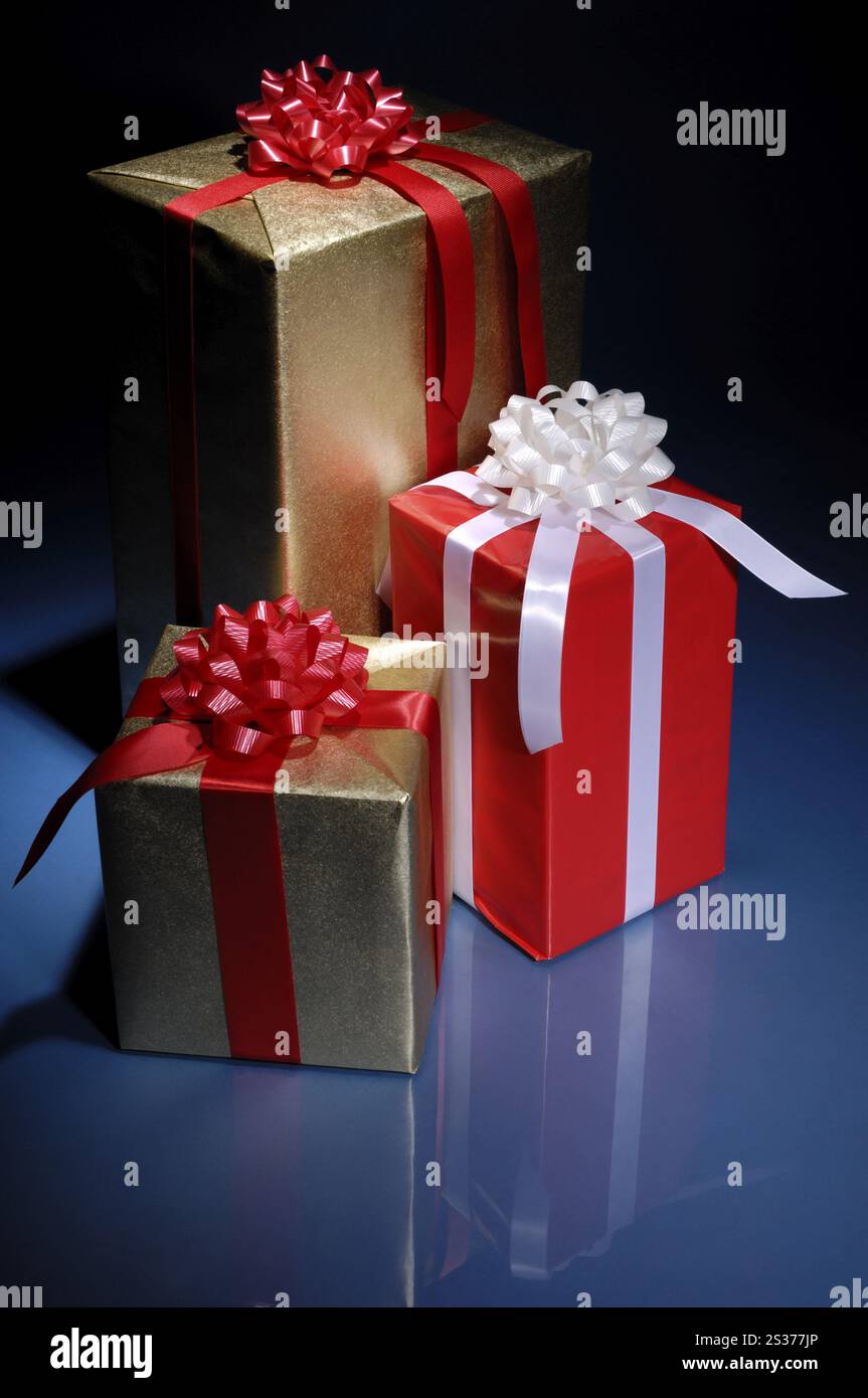 Christmas gift boxes shining in darkness Stock Photo - Alamy