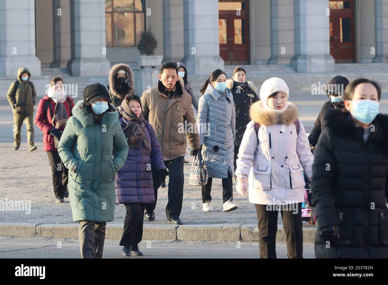 Pyongyang citizens walk in the street of the Central District in ...
