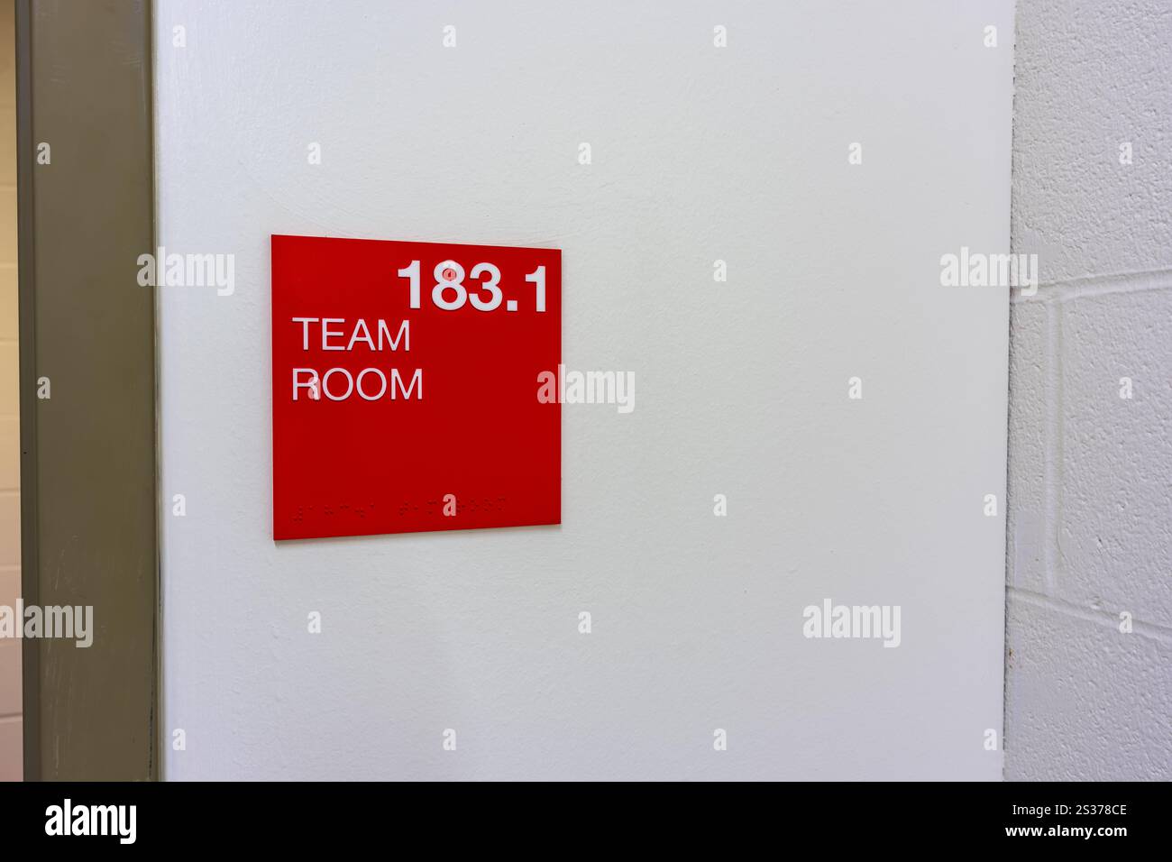 Red and white team room sign, 183.1, with braille code on a white ...
