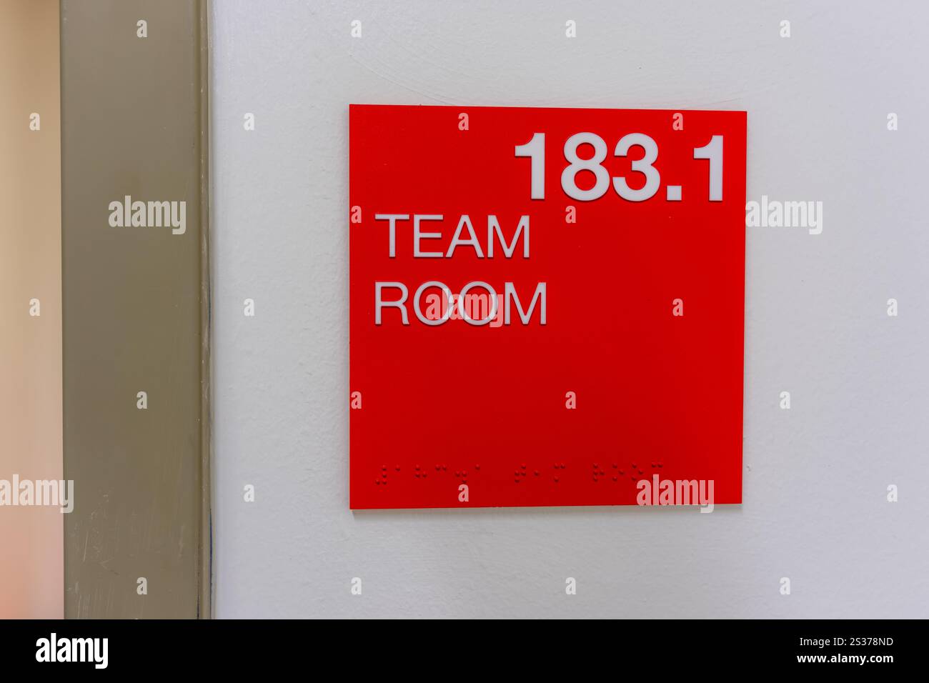 Red and white team room sign, 183.1, with braille code on a white ...