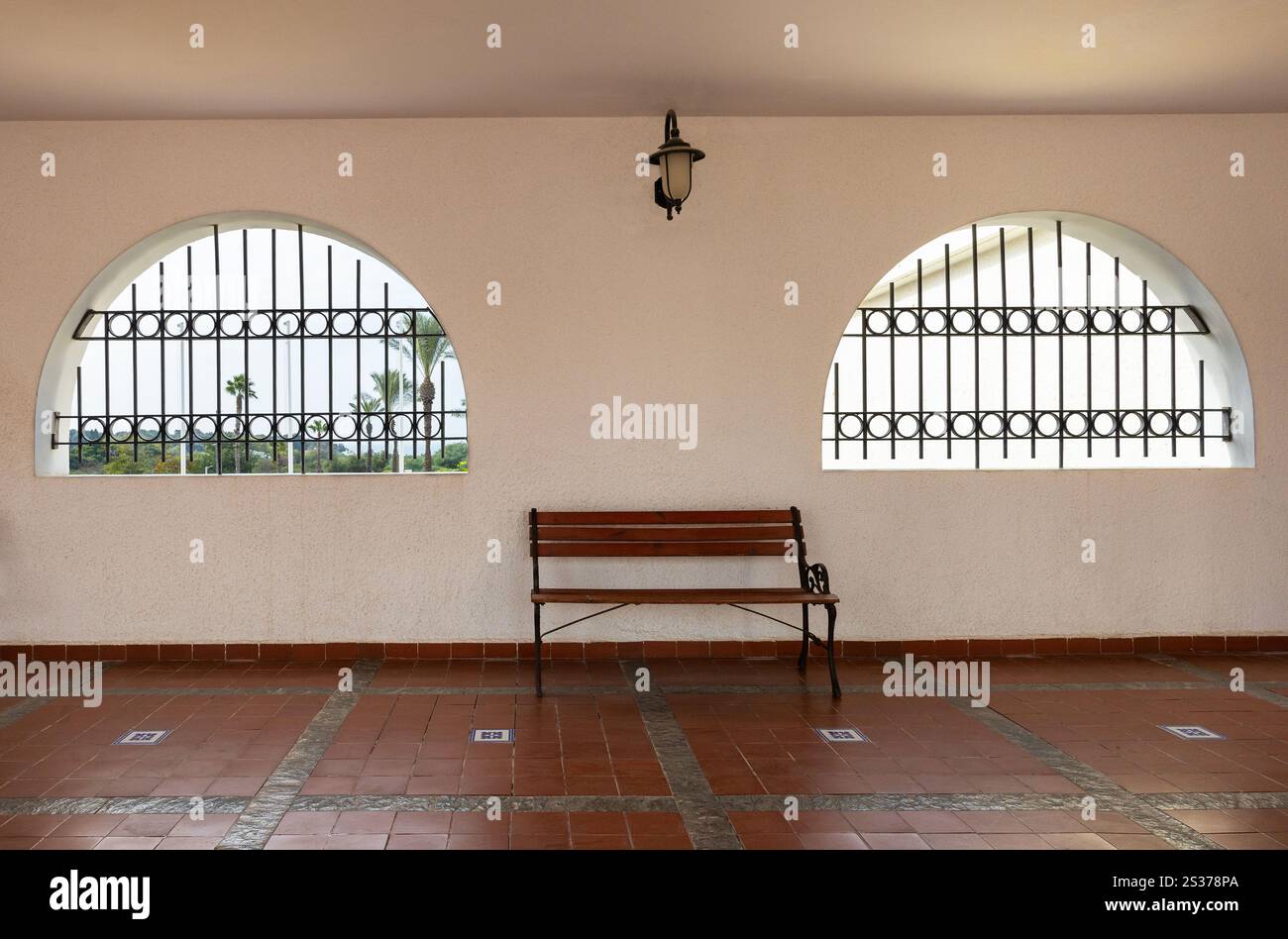 beautiful bench between two windows with bars Stock Photo - Alamy