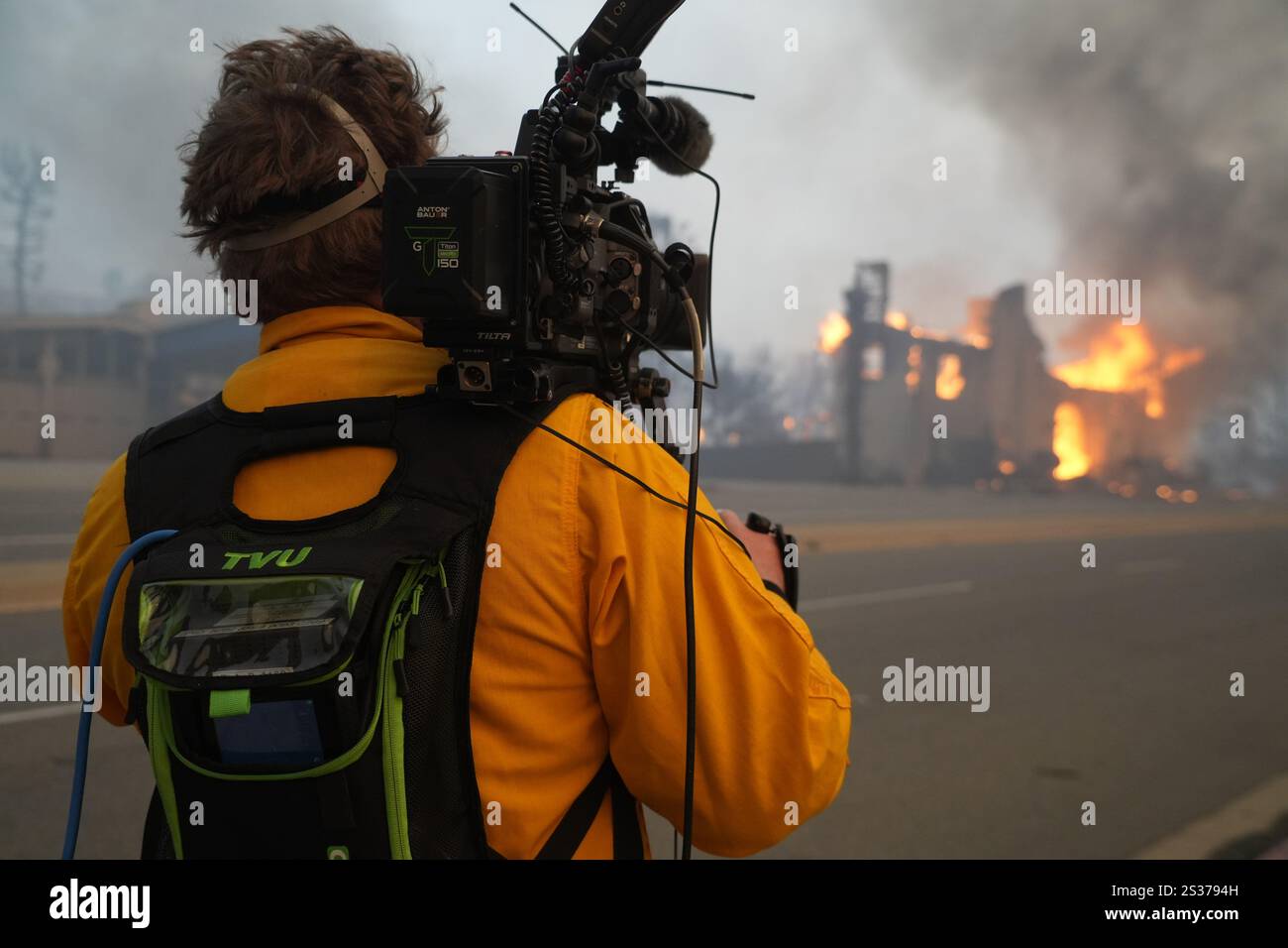 A media member films the Altadena Community Church burning during the ...