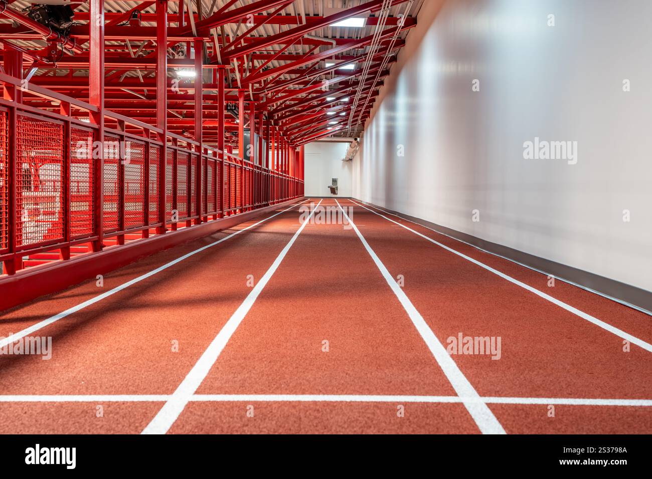 Close-up photo of the red elevated indoor running track with red ...