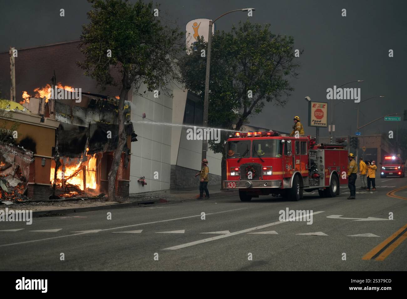 Los Angeles County Fire Dept. firefighters battle flames at the Iglesia ...