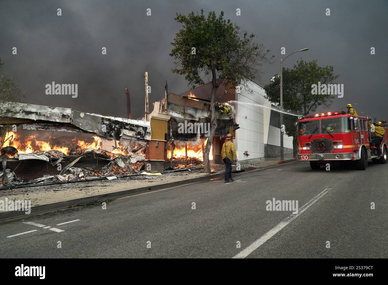 Los Angeles County Fire Dept. firefighters battle flames at the Iglesia ...