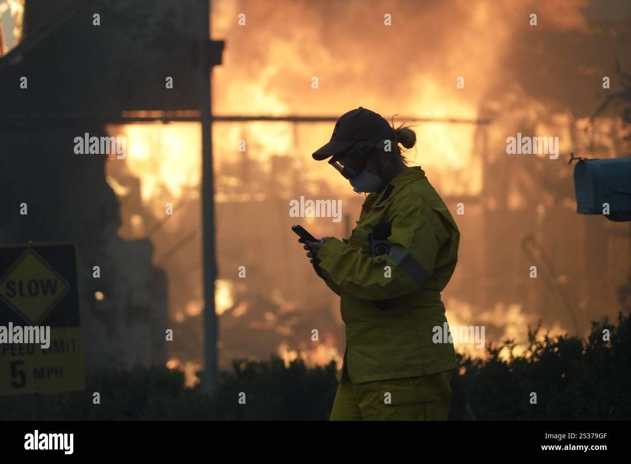 KCAL 9 News female television reporter Jasmine Viel stands by a burning ...