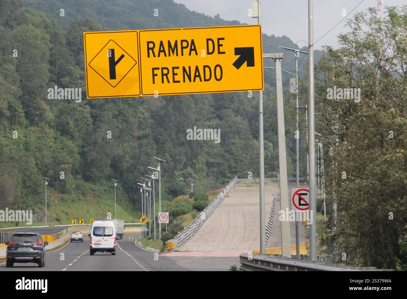 Sign on the highway to indicate a braking ramp to stop vehicles that ...