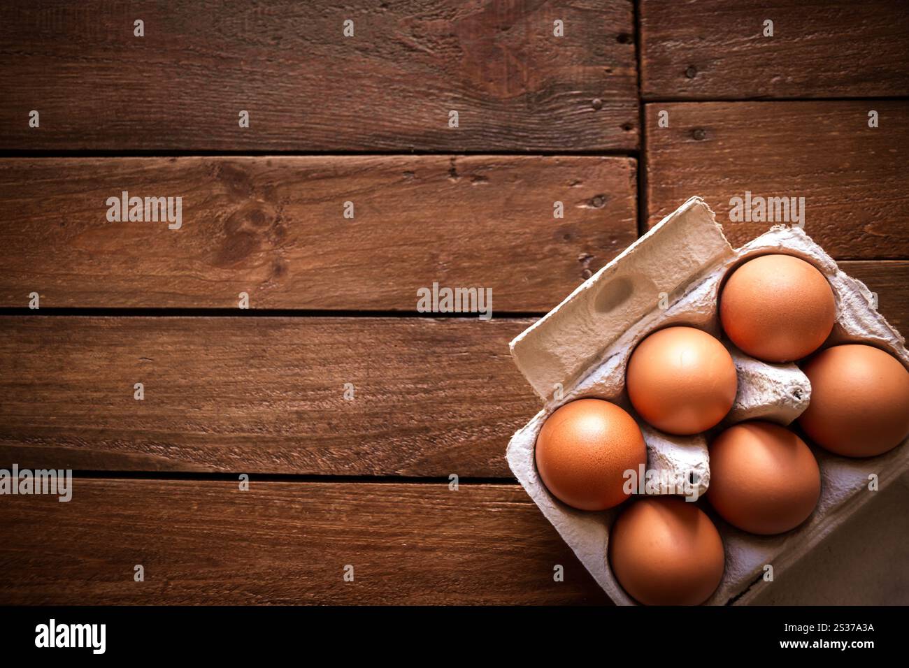 Fresh eggs box on a rustic wooden board background Stock Photo - Alamy