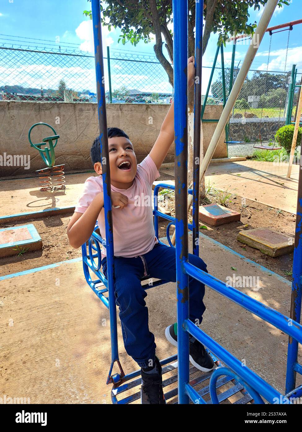9-year-old dark-skinned Latino male child practices balance exercises ...