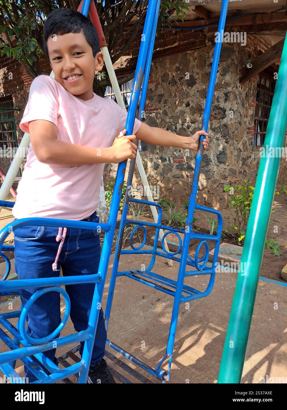 9-year-old dark-skinned Latino male child practices balance exercises ...