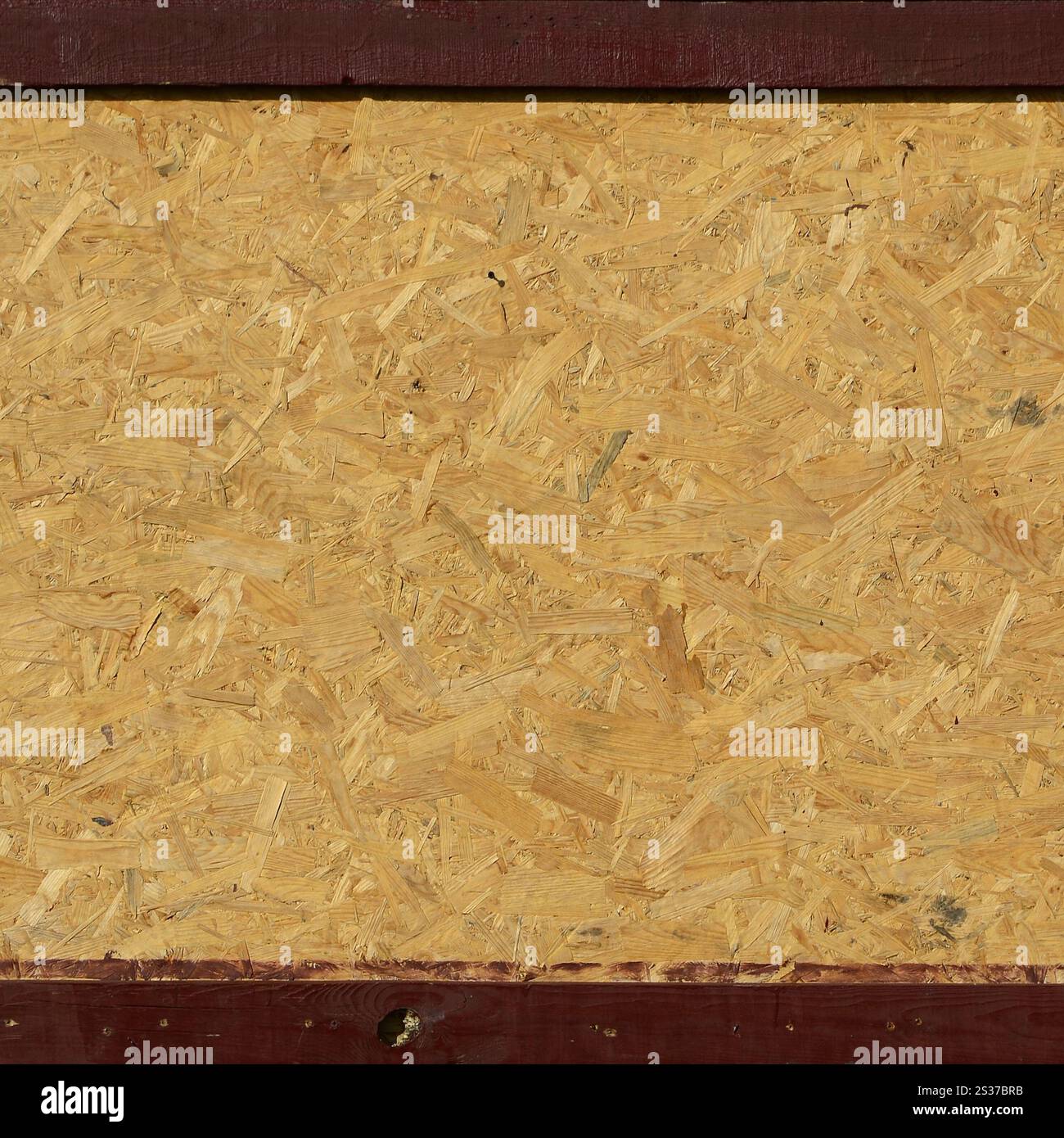 OSB boards are made of brown wood chips sanded into a wooden background ...