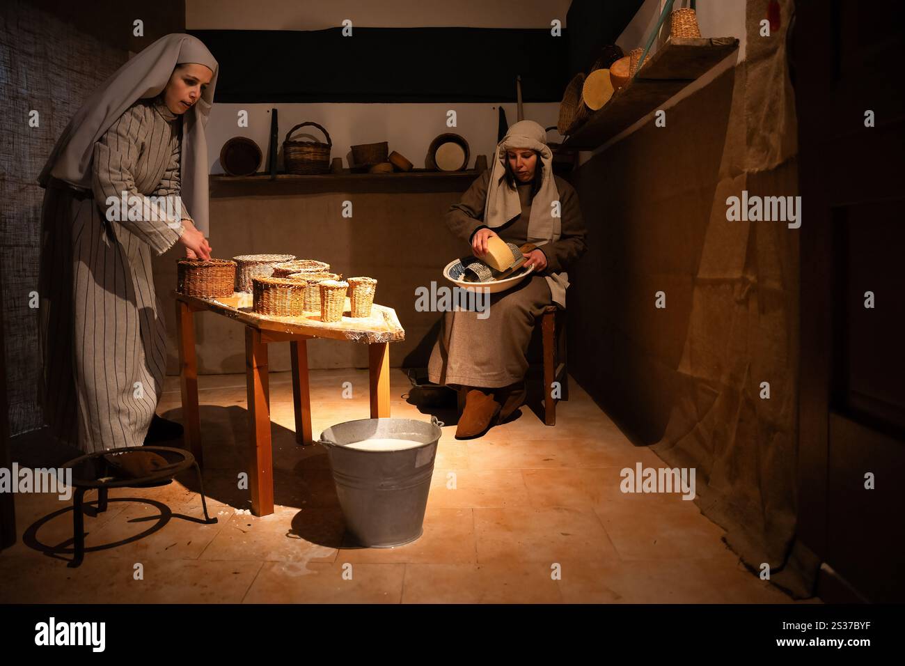 Morcone, Italy. 04th Jan, 2025. Two women work with milk to make cheese ...