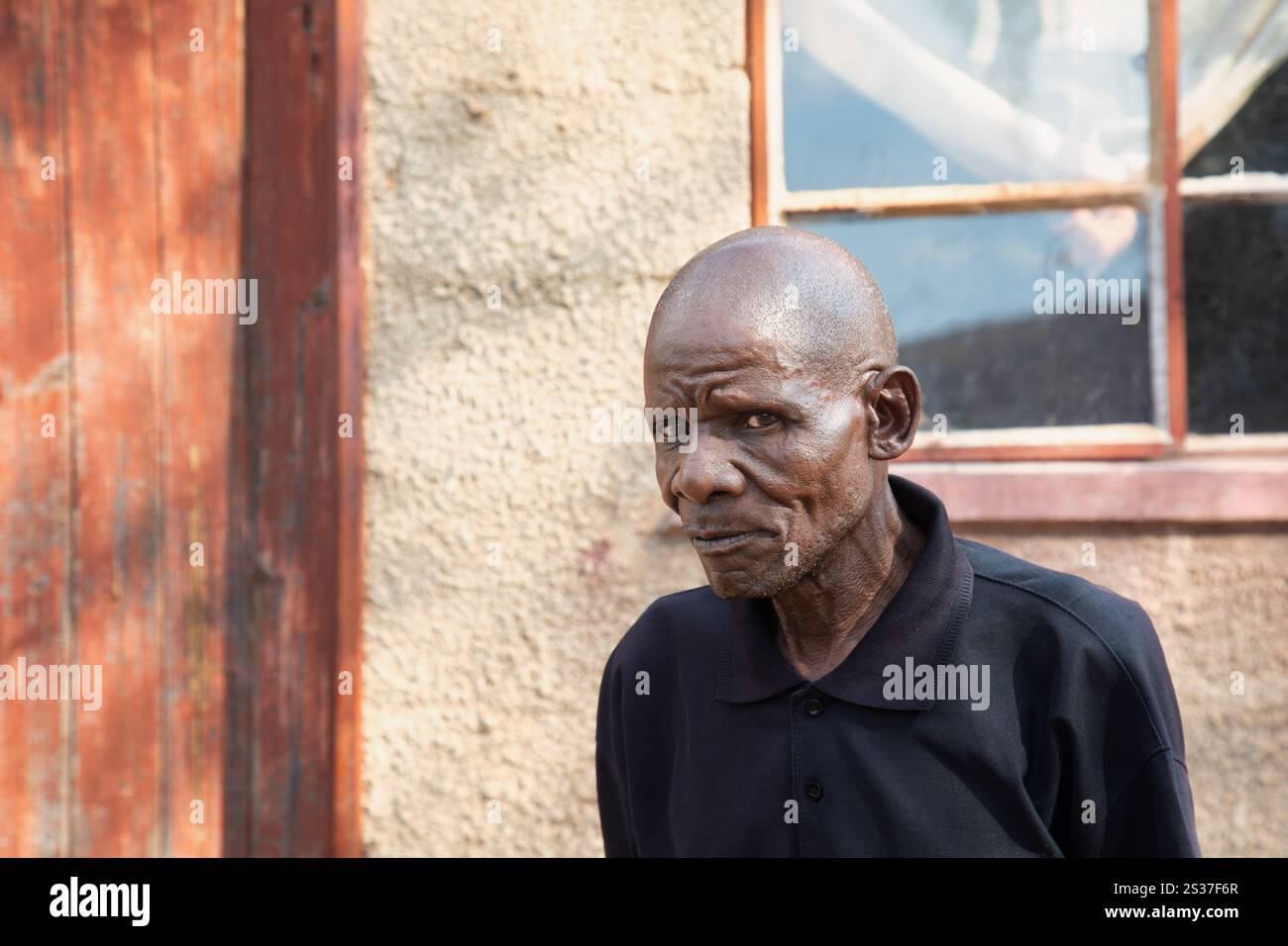 african village, portrait of single old african man in front of the ...