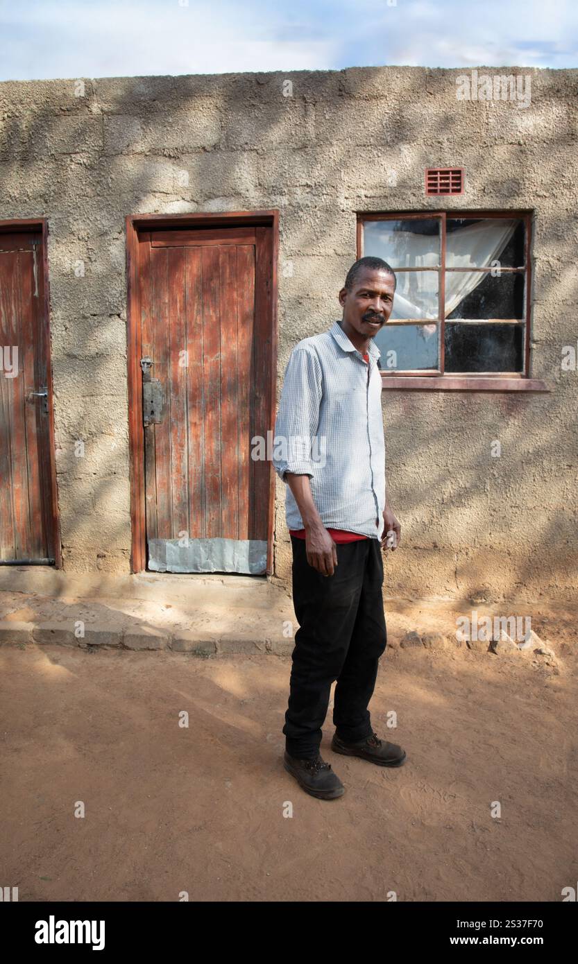 african village, portrait of single african man in front of the house ...