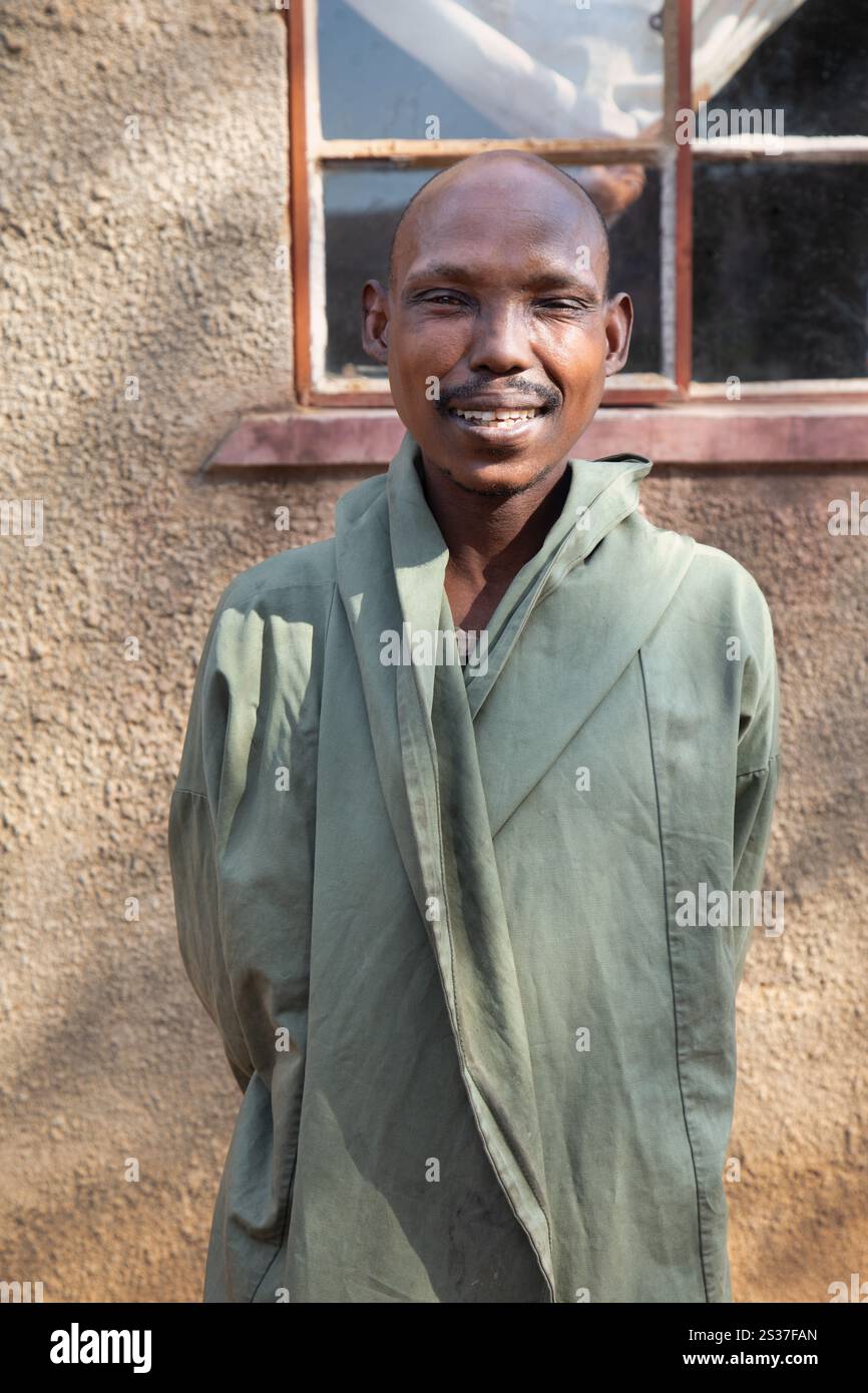 african village, portrait of single happy african man in front of the ...