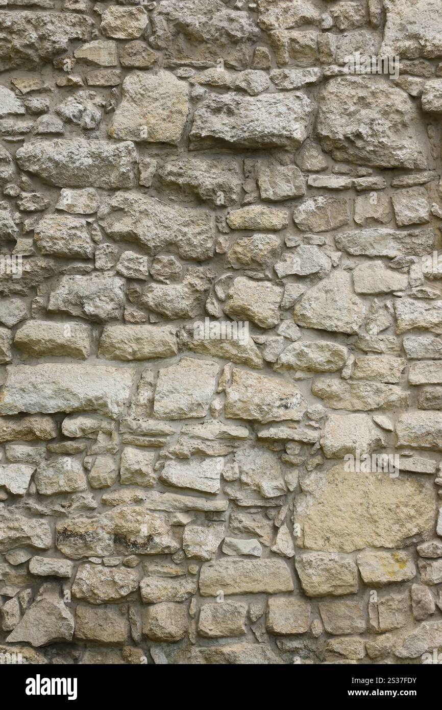 Texture of a stone wall with many big brown and grey stones armed with ...