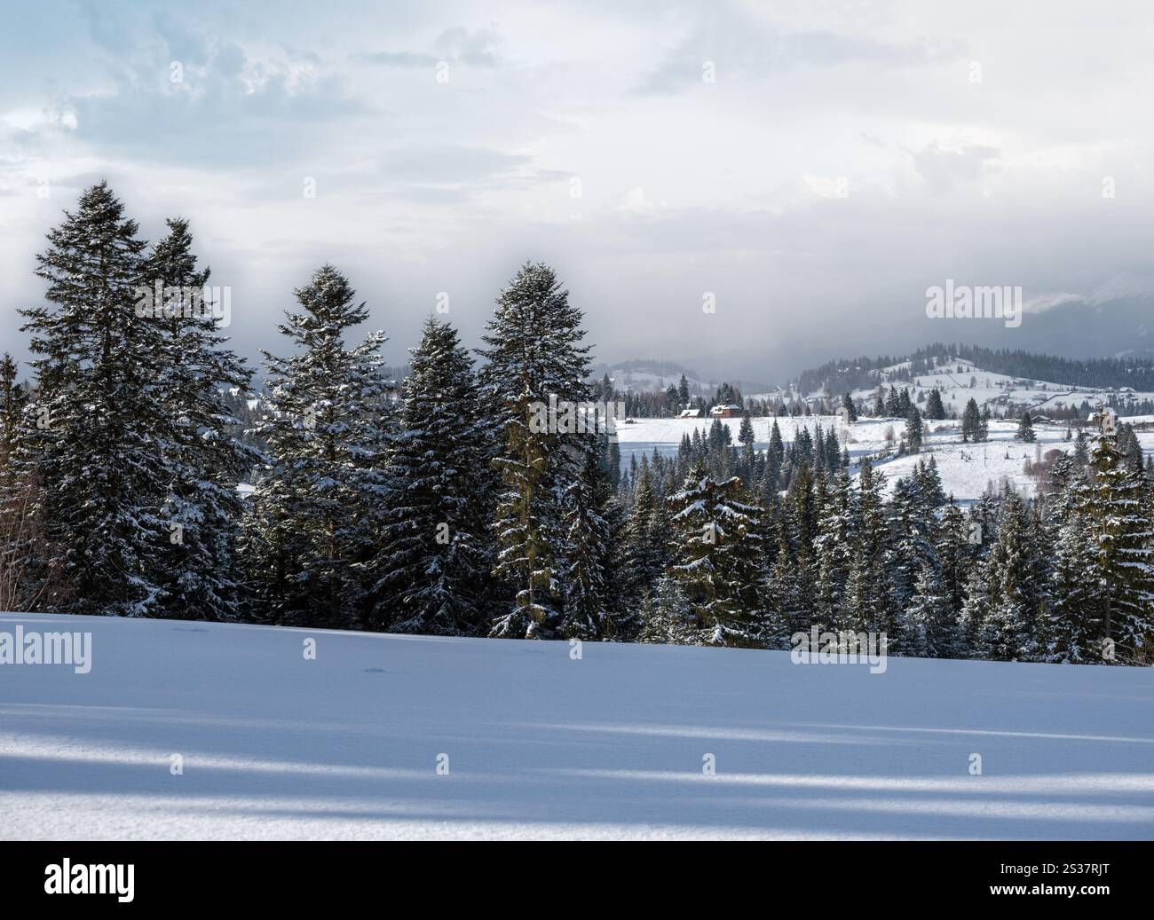 Winter remote alpine mountain village outskirts, countryside hills ...