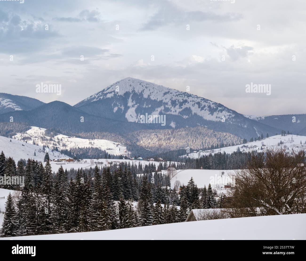 Winter remote alpine mountain village outskirts, countryside hills ...