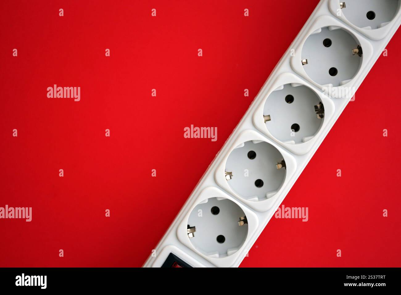 White electrical multi plug extender with european socket on bright red ...