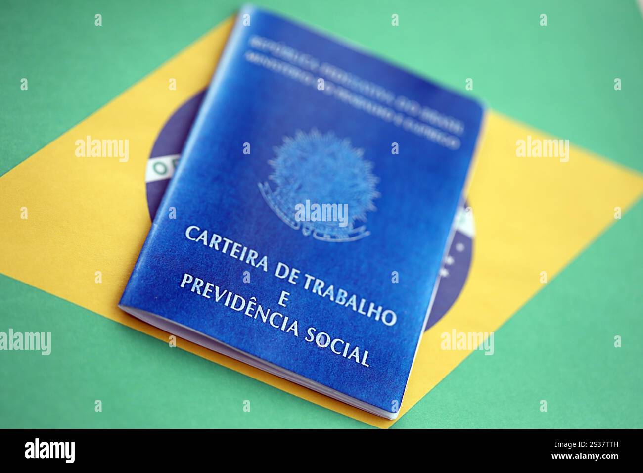 Brazilian work card and social security blue book on flag of Federative ...