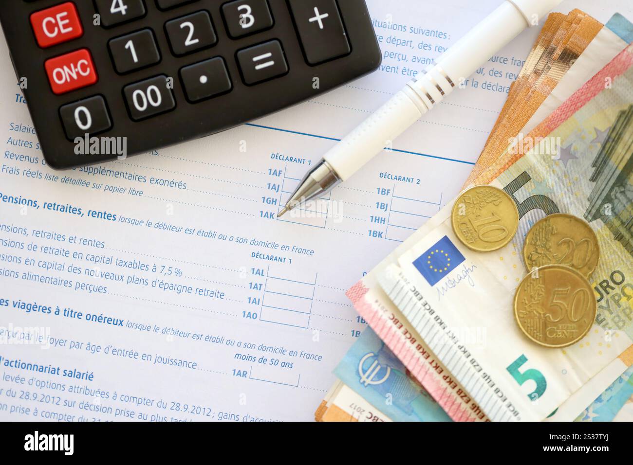Filling french tax form process with calculator, pen and euro money ...
