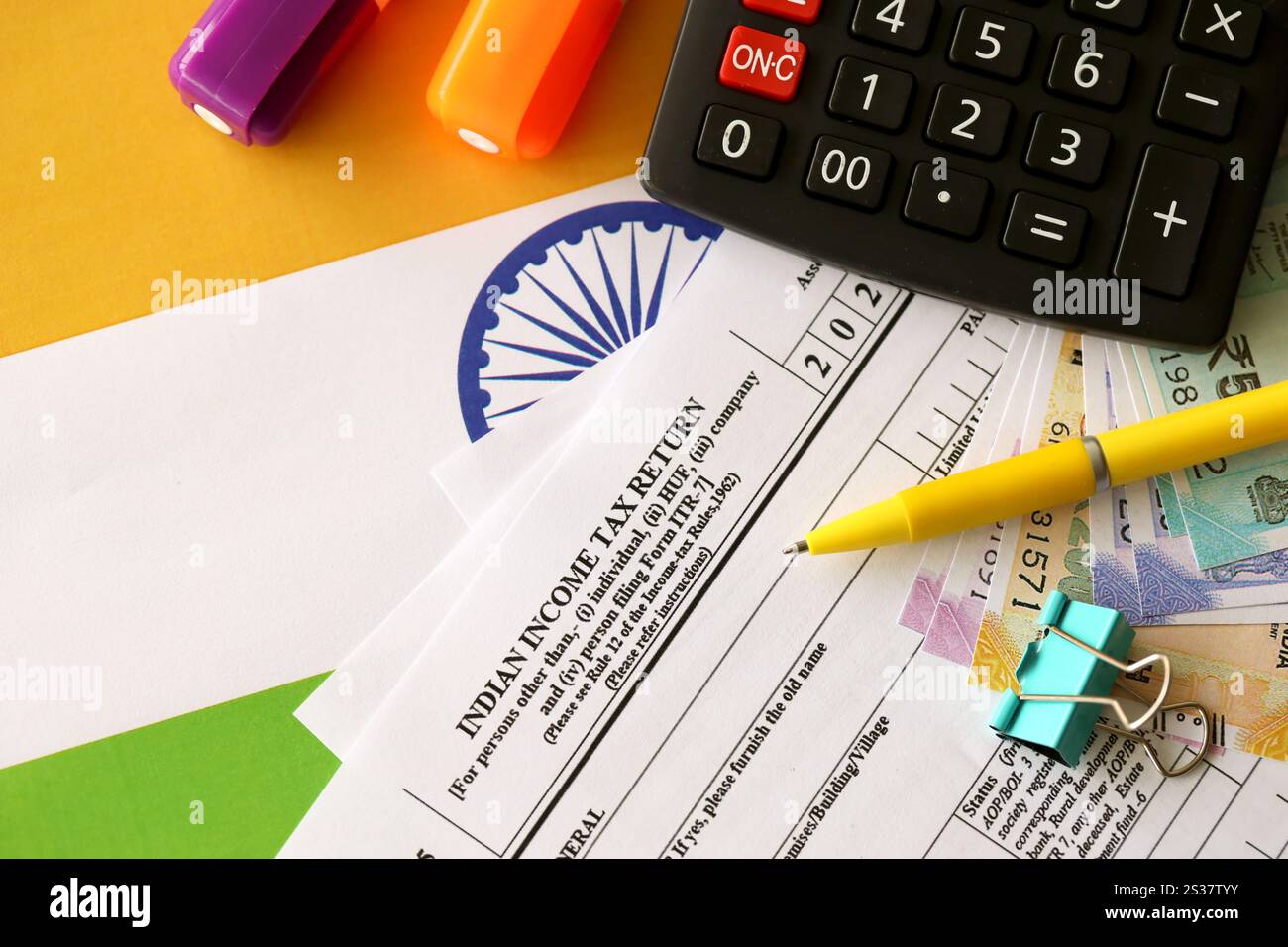 Indian income tax return blank form with pen and indian rupees bills on ...