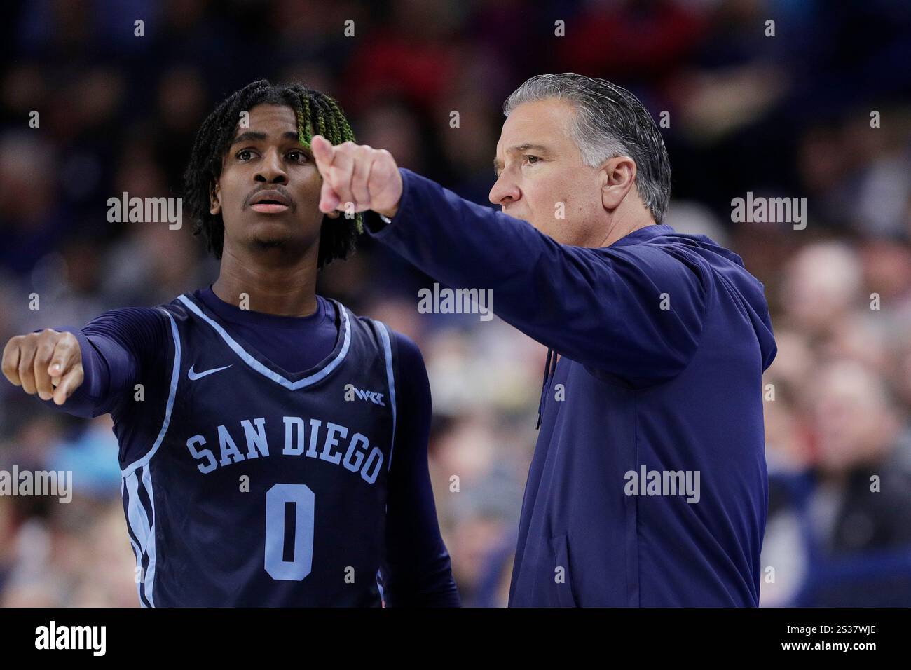 San Diego head coach Steve Lavin, right, speaks with guard Kjay Bradley ...