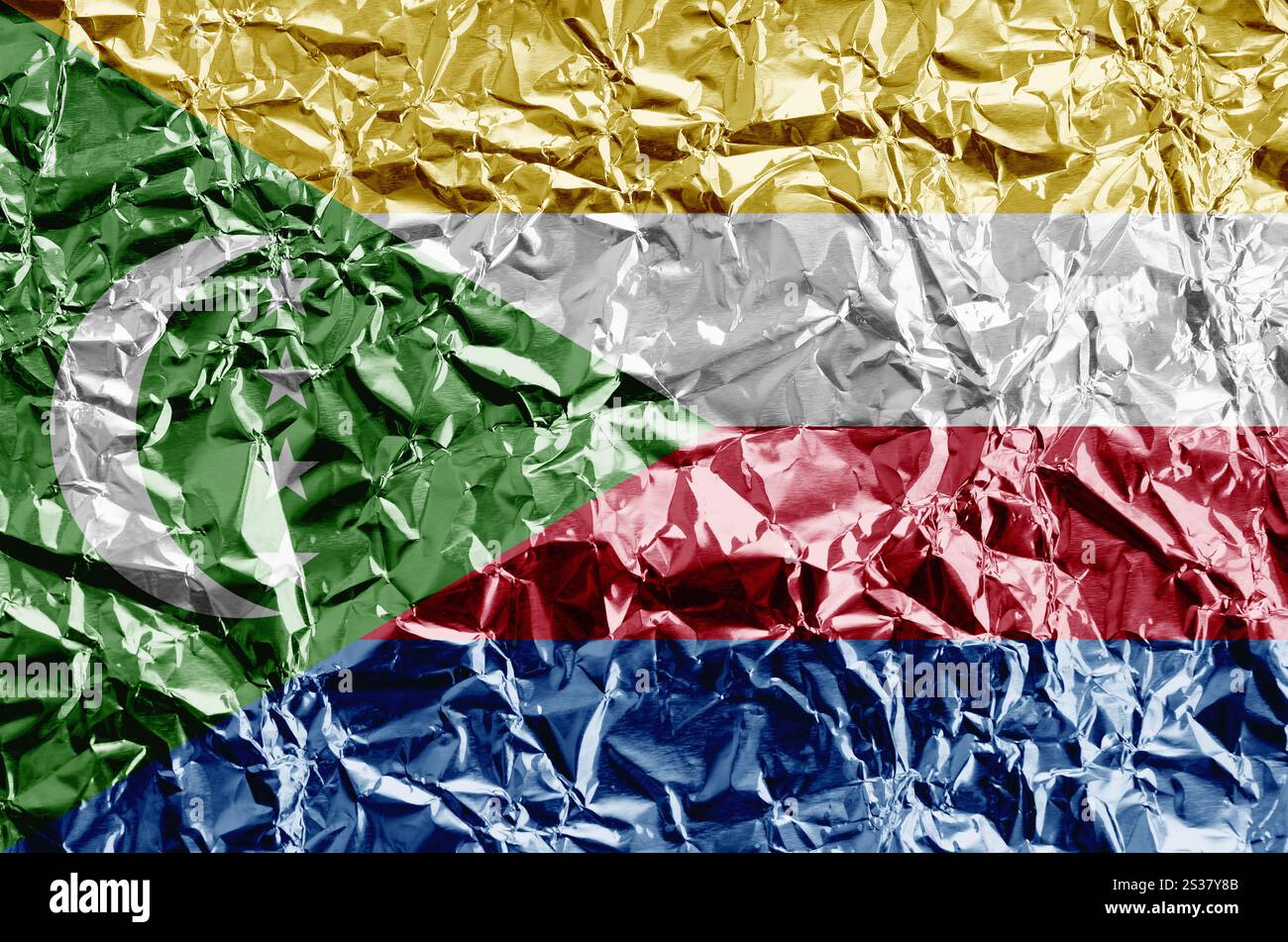Comoros flag depicted in paint colors on shiny crumpled aluminium foil ...