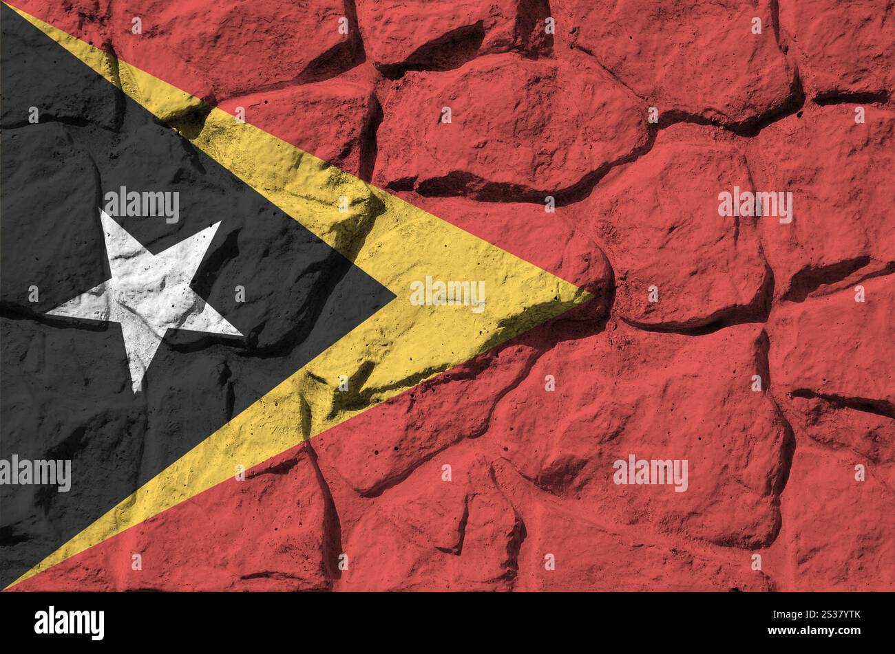 Timor Leste flag depicted in paint colors on old stone wall close up ...