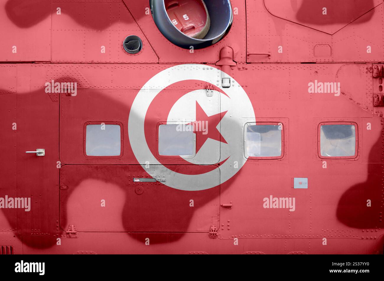 Tunisia flag depicted on side part of military armored helicopter close ...
