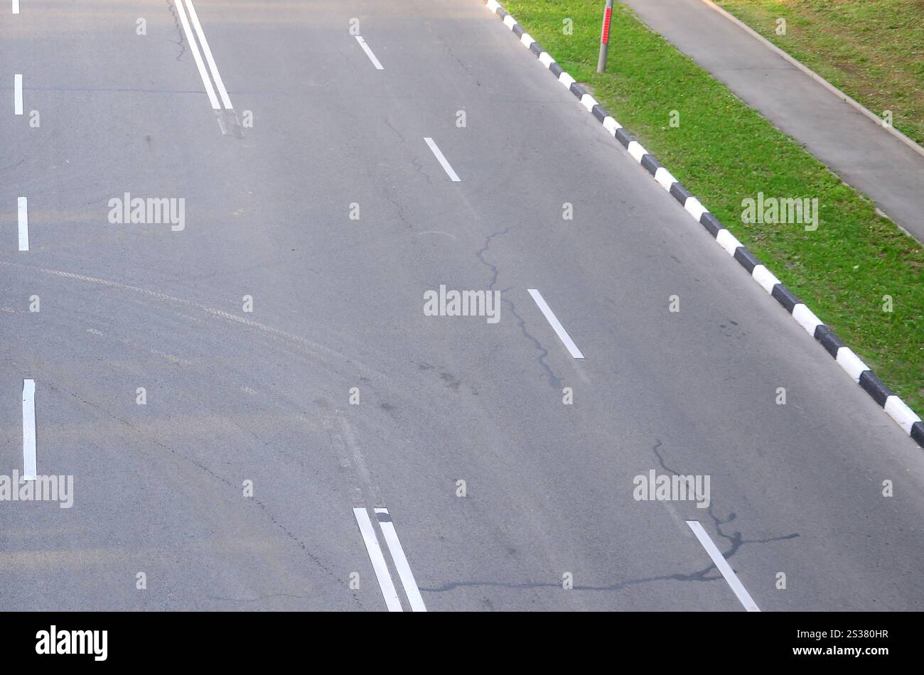 Damaged bad asphalt road with potholes. Patch repair of asphalt. Bad ...