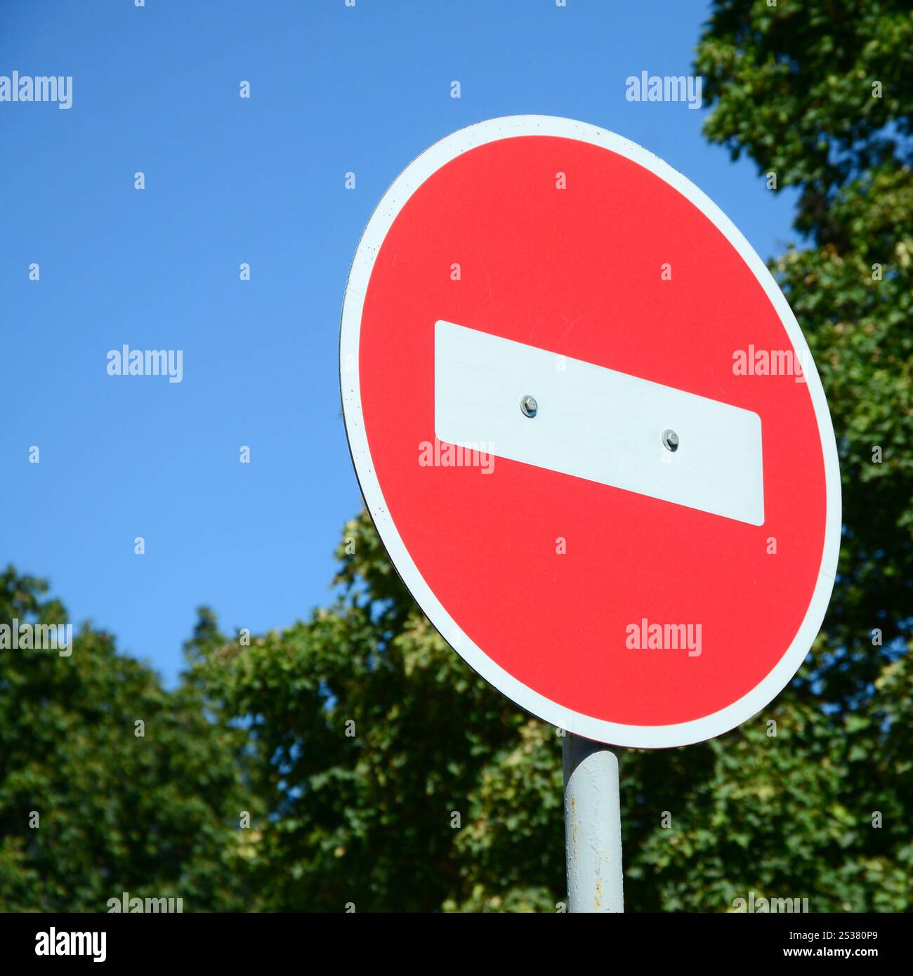 A circular red sign with a white bar indicating NO ENTRY on a grey ...