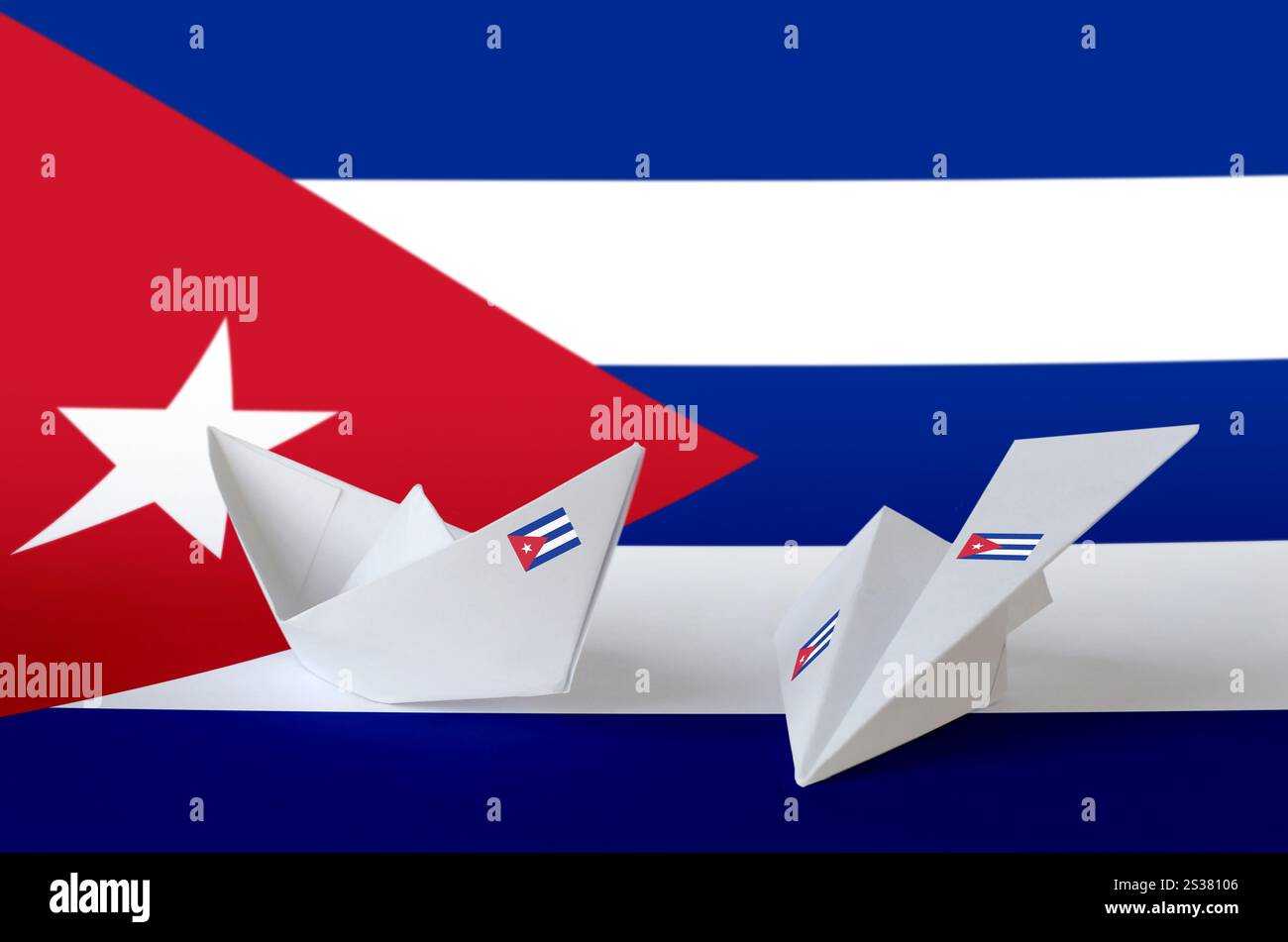 Cuba flag depicted on paper origami airplane and boat. Oriental ...
