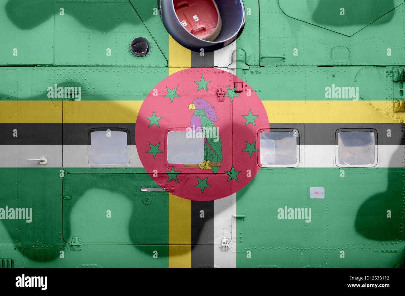 Dominica flag depicted on side part of military armored helicopter ...