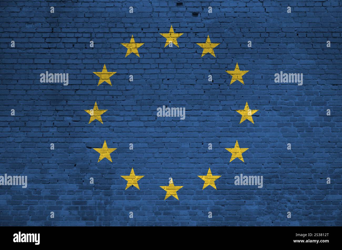 European union flag depicted in paint colors on old brick wall close up ...