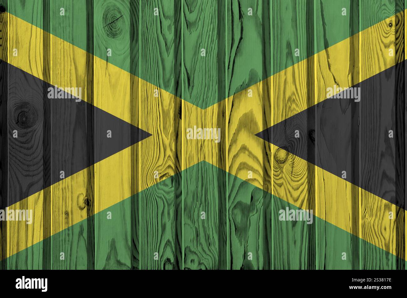 Jamaica flag depicted in bright paint colors on old wooden wall close ...