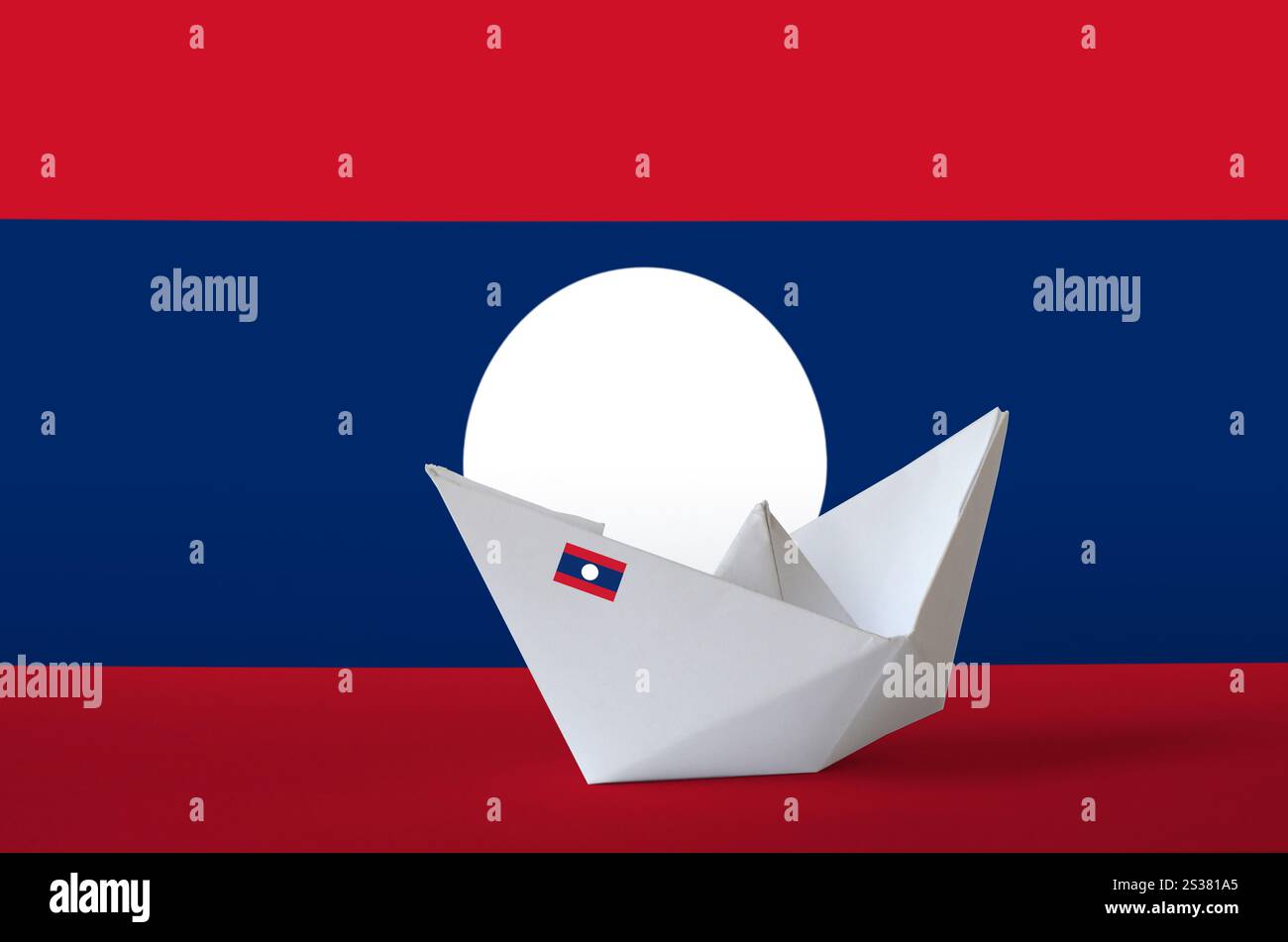 Laos flag depicted on paper origami ship closeup. Oriental handmade ...