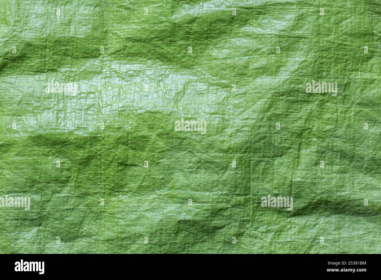 Green tarpaulin waterproof sheet background. Versatile material used in ...