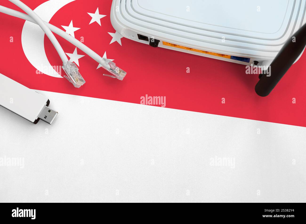 Singapore flag depicted on table with internet rj45 cable, wireless usb ...