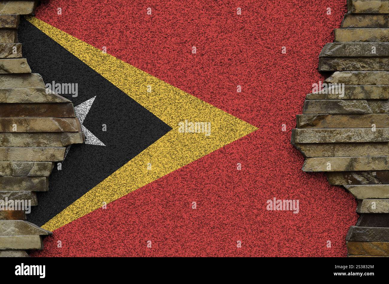 Timor Leste flag depicted in paint colors on old stone wall close up ...