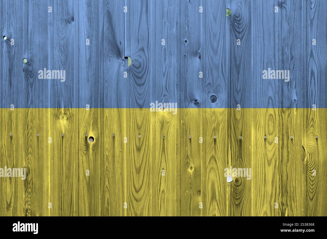Ukraine flag depicted in bright paint colors on old wooden wall close ...