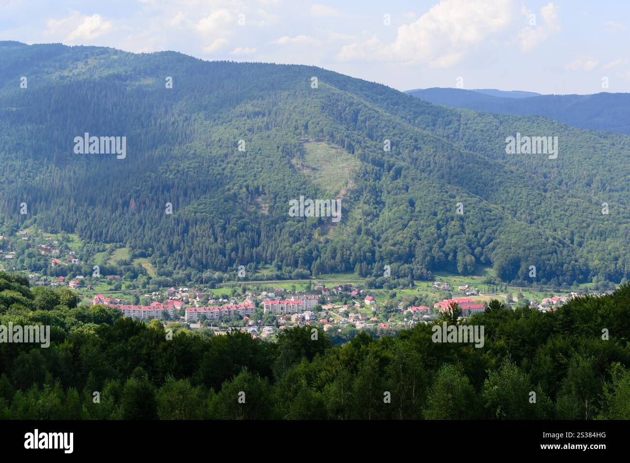 Landscape city between mountains and forest. Photo nature. Landscape ...