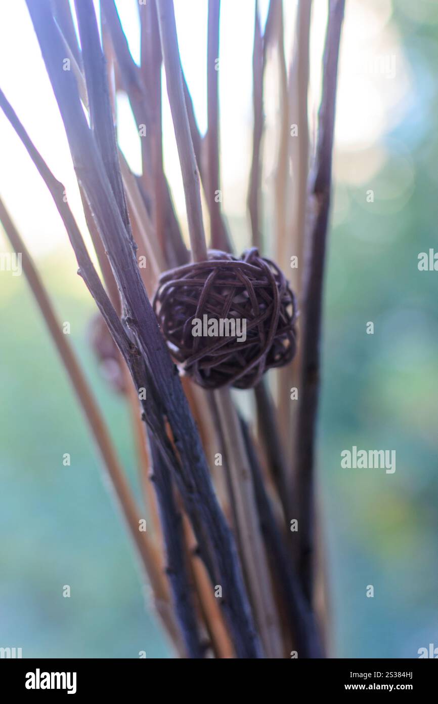 Macro decor wicker ball on the dry branches of a blurred background ...