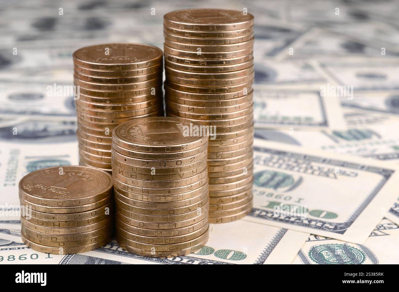 Stack of ukrainian coins in rising stacks grow up. Ukrainian money lies ...