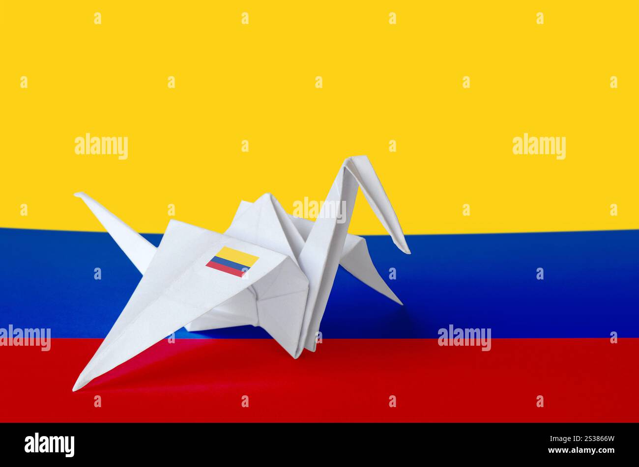 Colombia flag depicted on paper origami crane wing. Oriental handmade ...