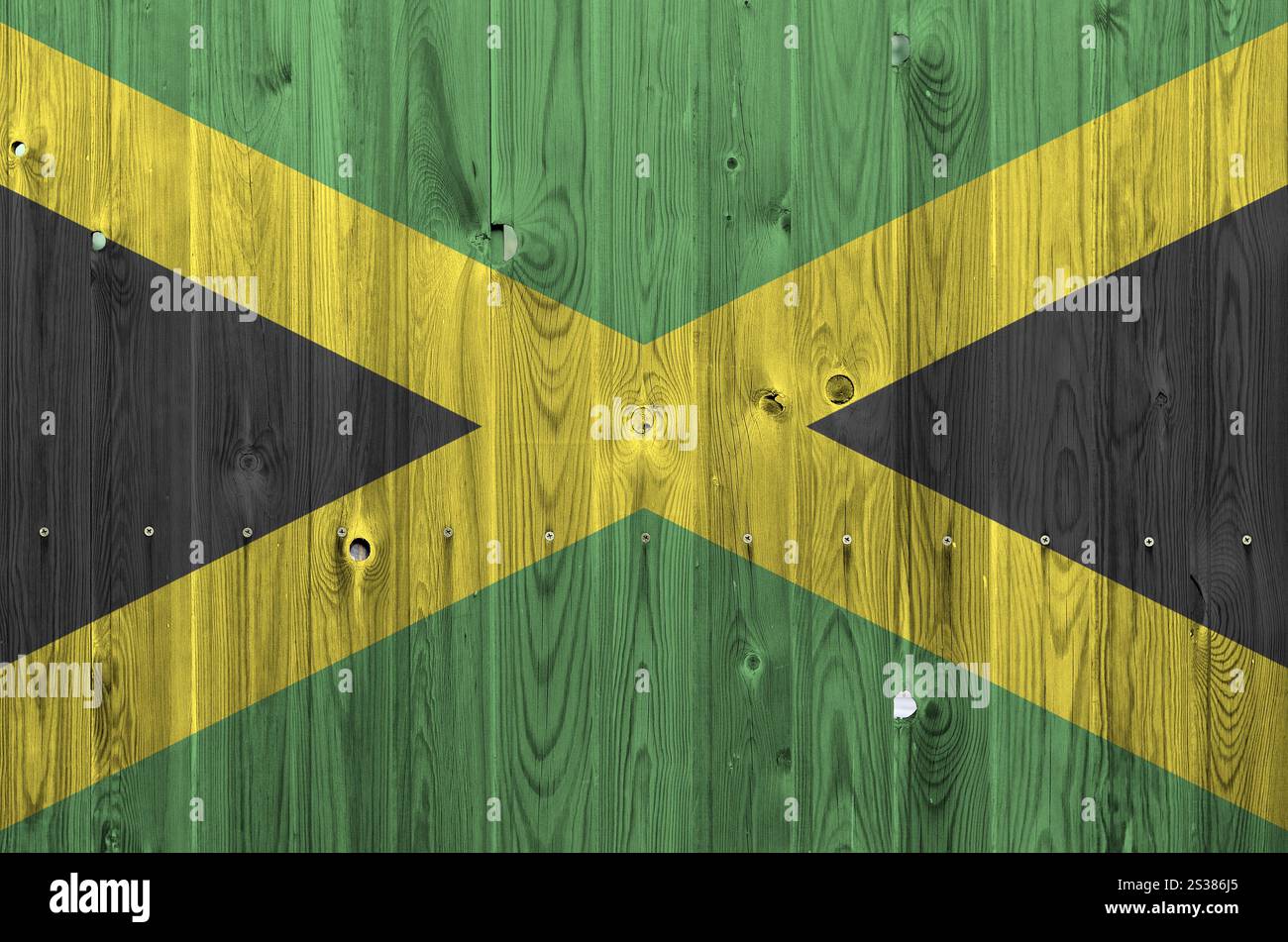 Jamaica flag depicted in bright paint colors on old wooden wall close ...