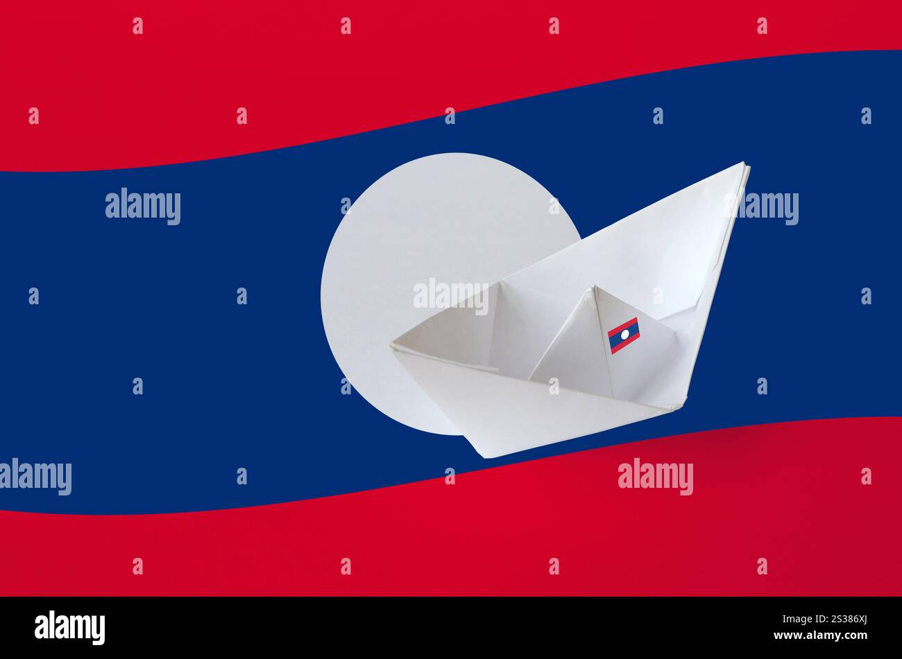 Laos flag depicted on paper origami ship closeup. Oriental handmade ...