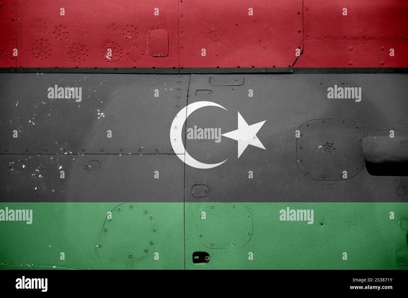 Libya flag depicted on side part of military armored helicopter close ...